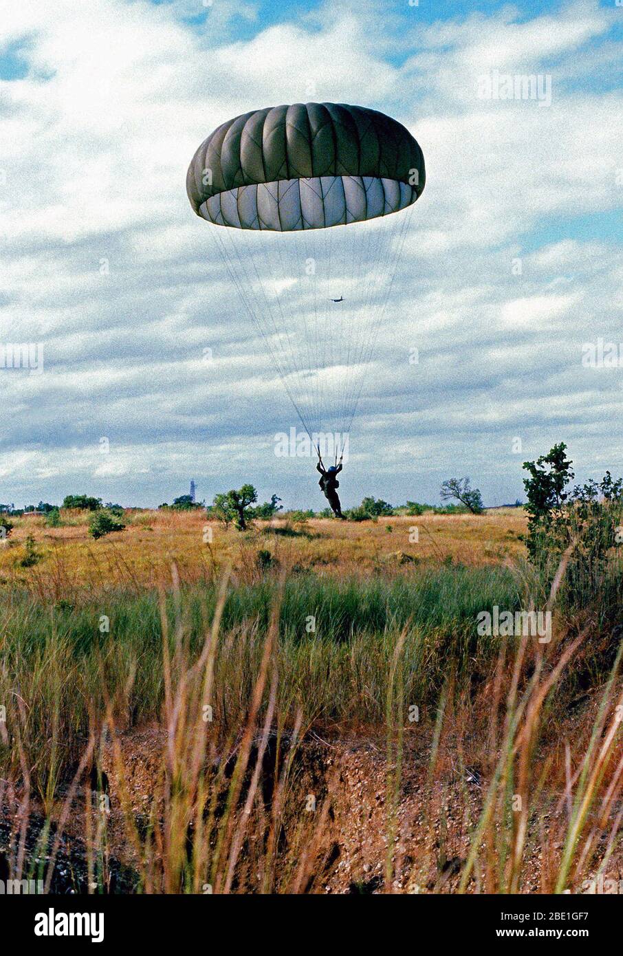 A Philippine army paratrooper lands at the drop zone during a 374th ...