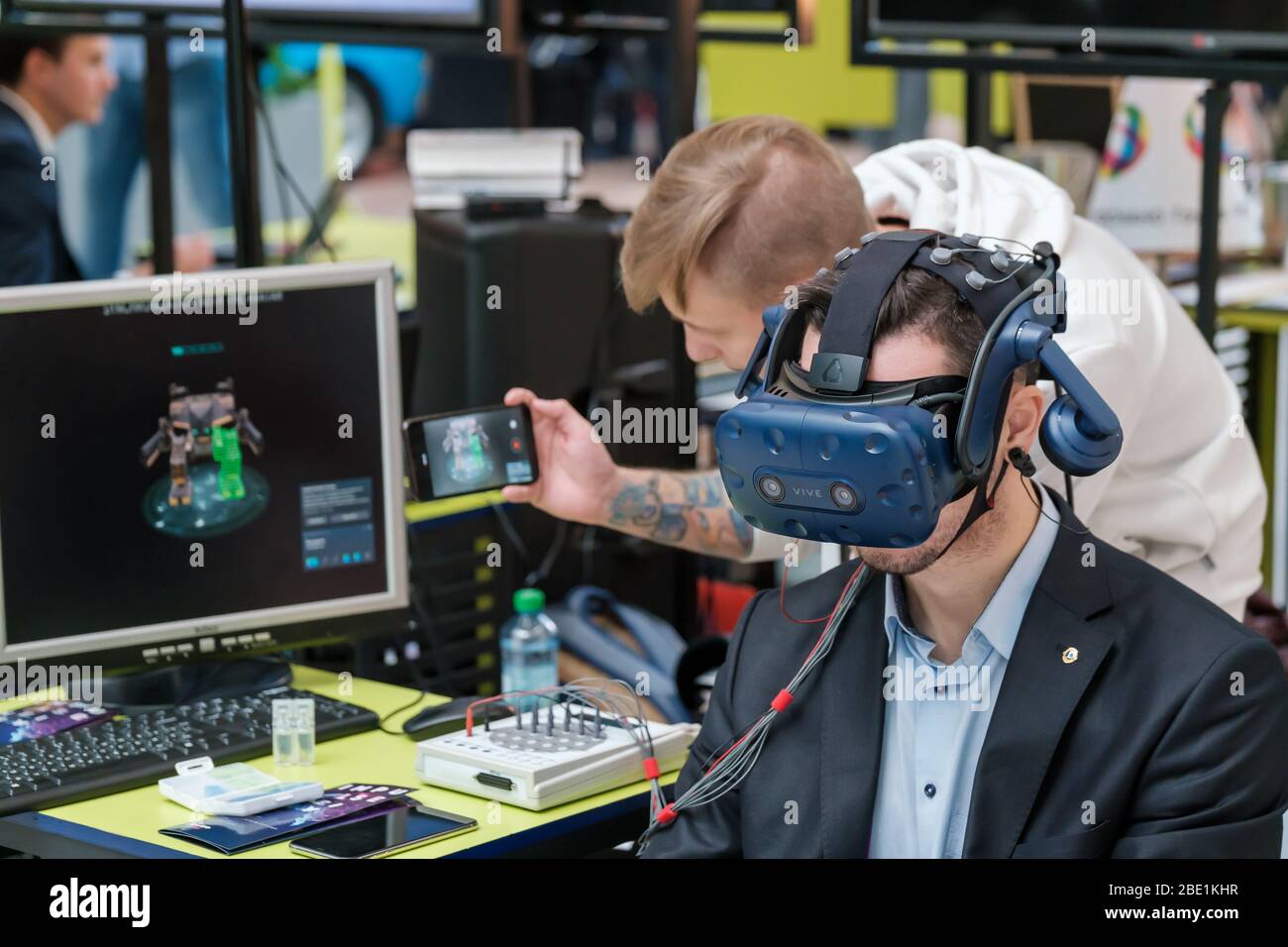 VR conference visitor tests virtual reality helmet Stock Photo - Alamy