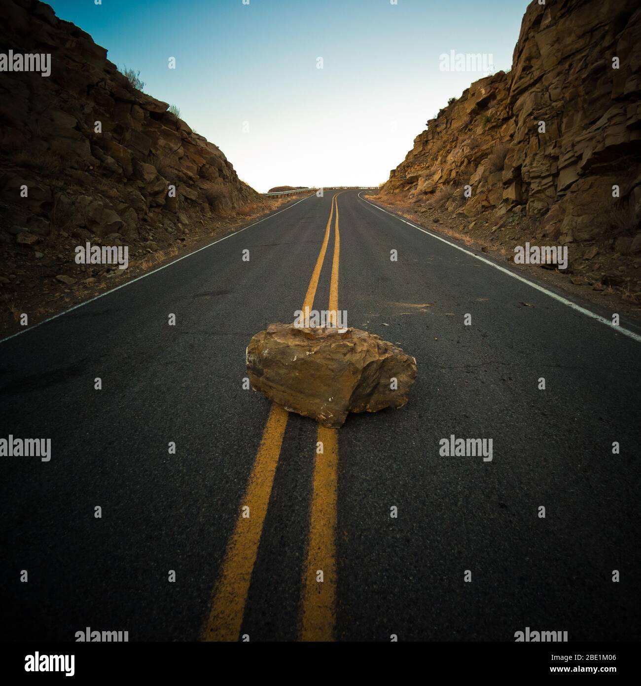 Rock hazard in the road Stock Photo - Alamy