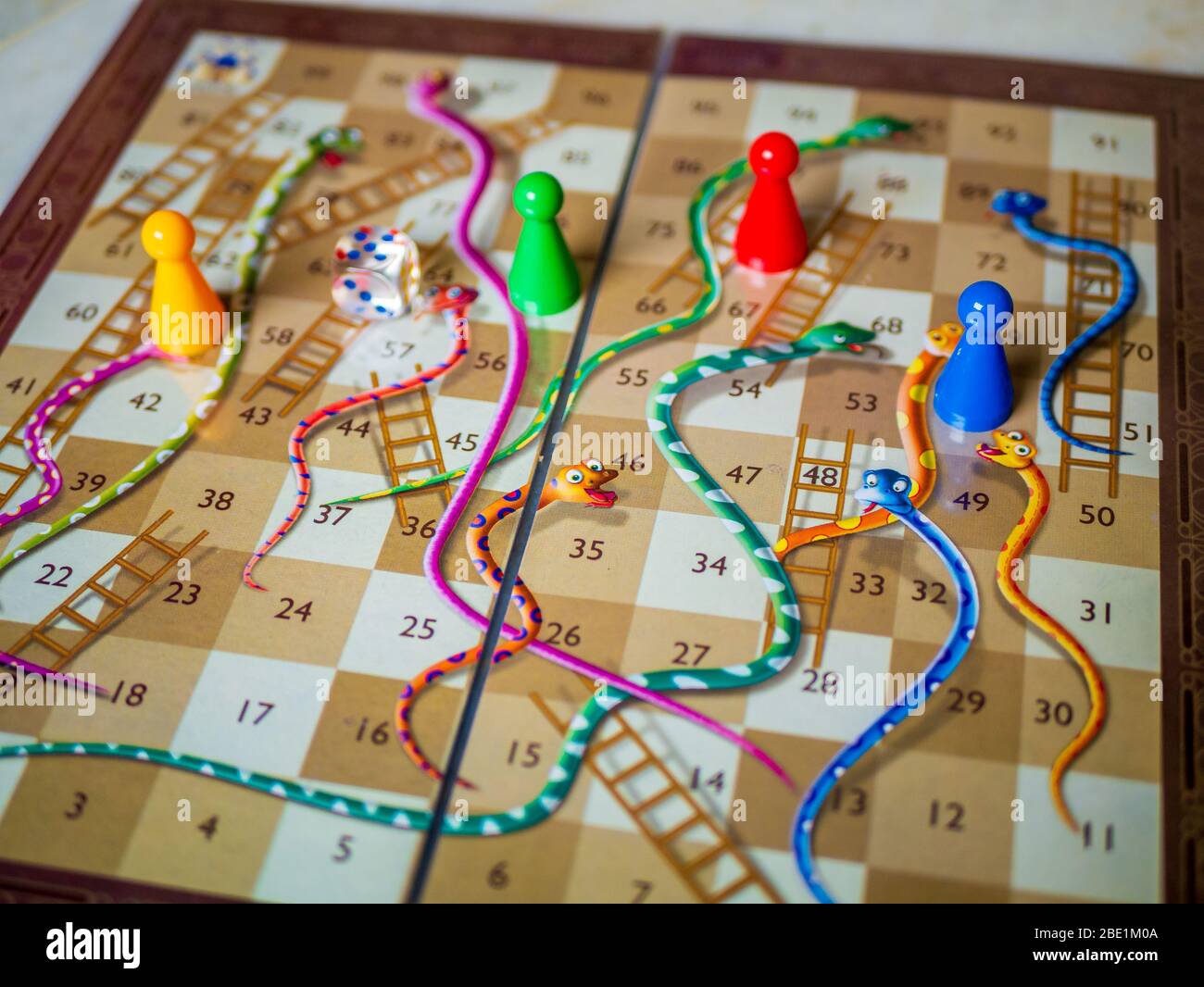 Closeup image of a Snakes and Ladders game Stock Photo - Alamy