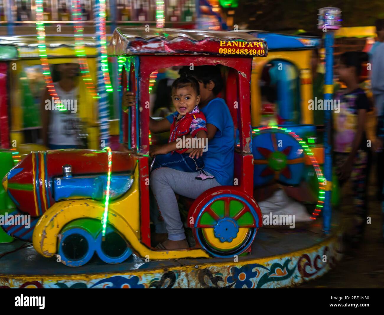 Mumbai, India - December 01, 2019: Indian kid enjoying carousel ride in ...