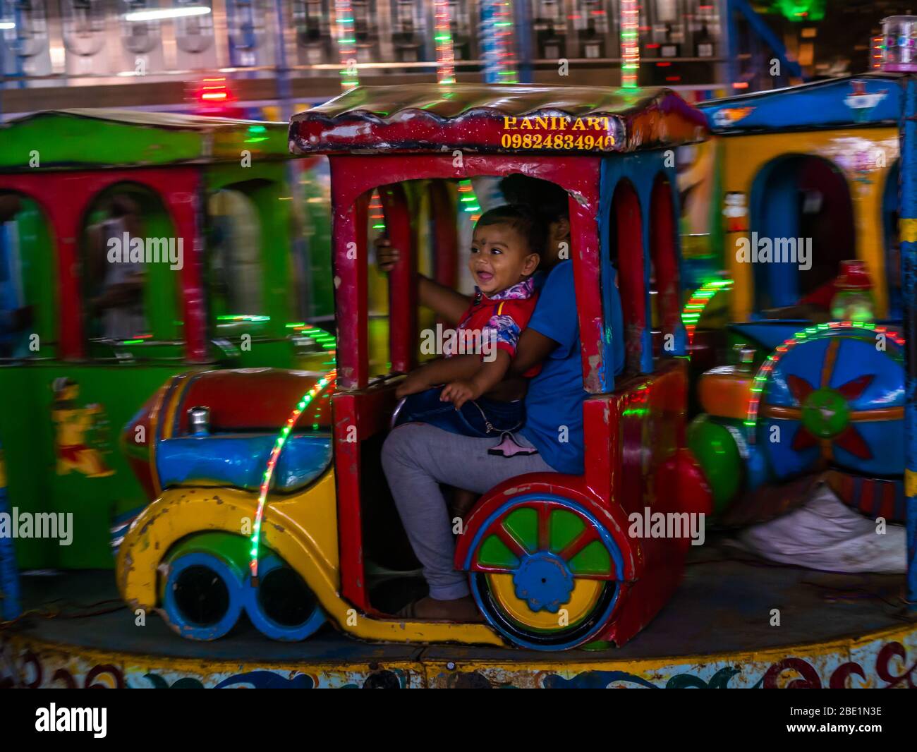 Mumbai, India - December 01, 2019: Indian kid enjoying carousel ride in ...