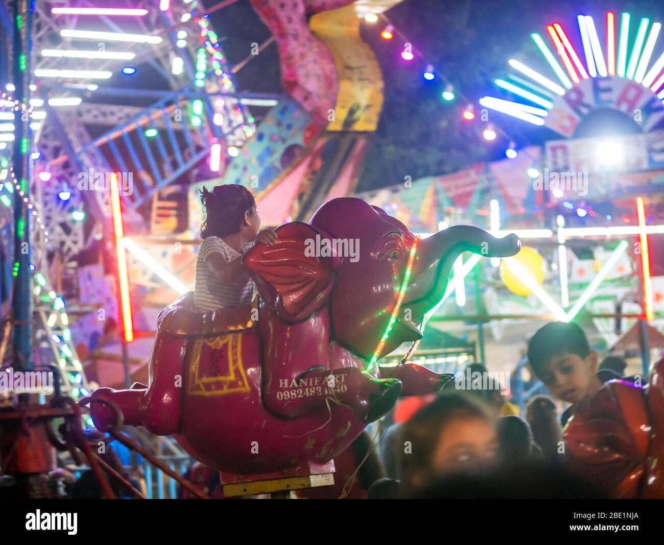 Mumbai, India - December 01, 2019: Indian kids enjoying carousel ride ...