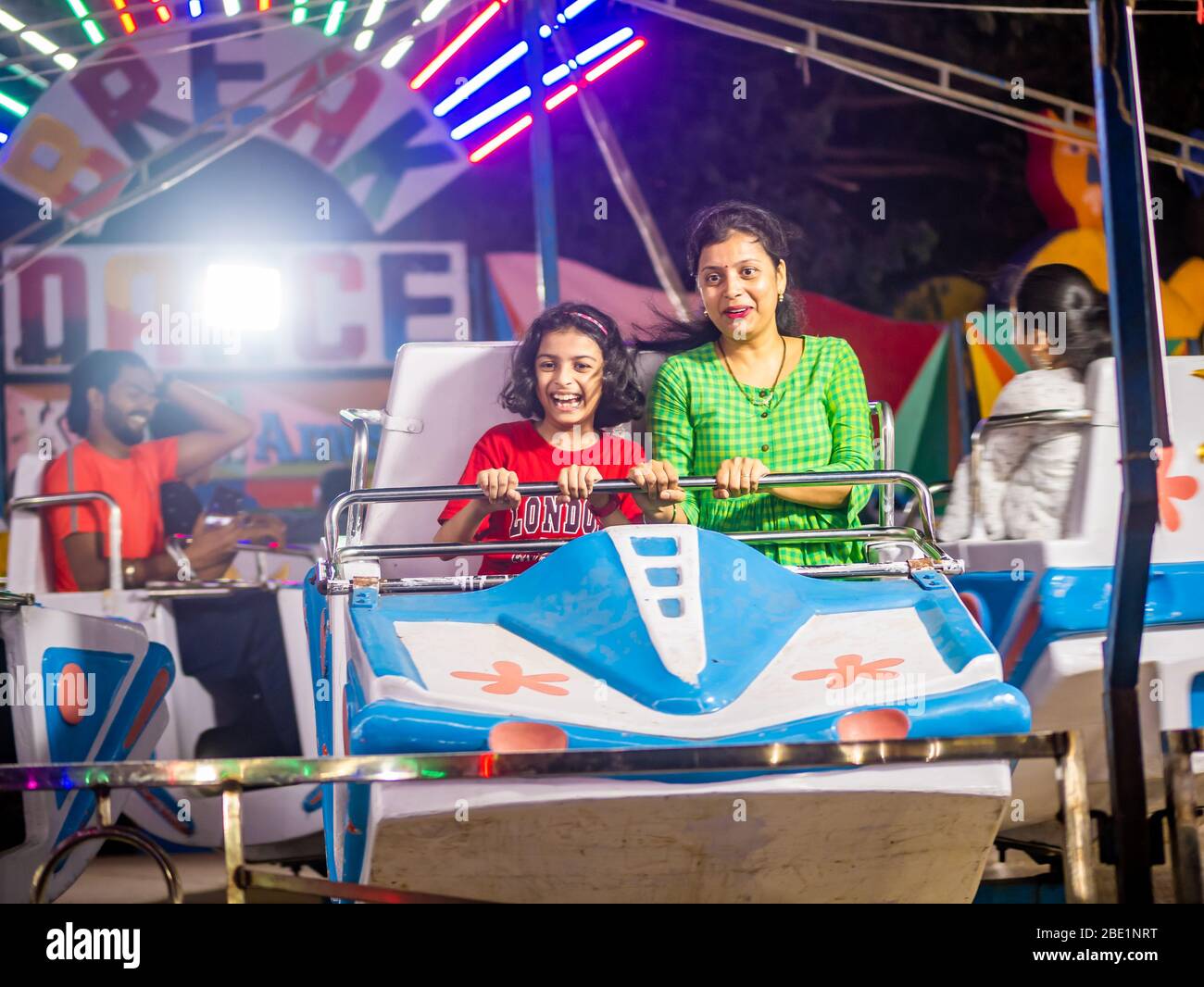 Mumbai, India - December 01, 2019: Indian family enjoying carousel ride ...