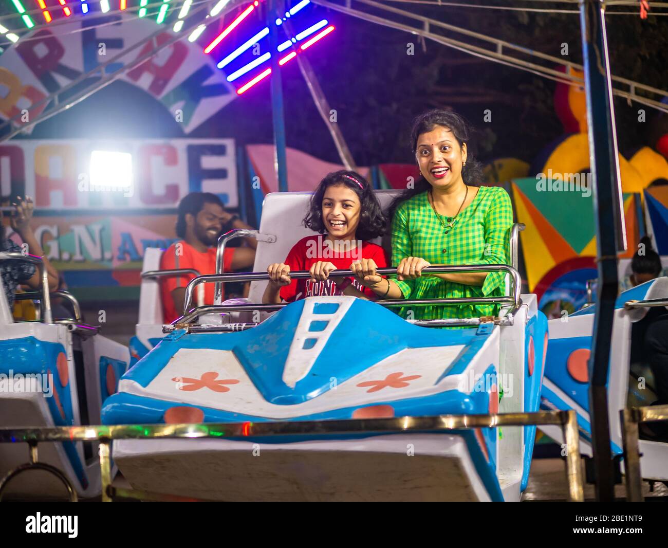 Mumbai, India - December 01, 2019: Indian family enjoying carousel ride ...