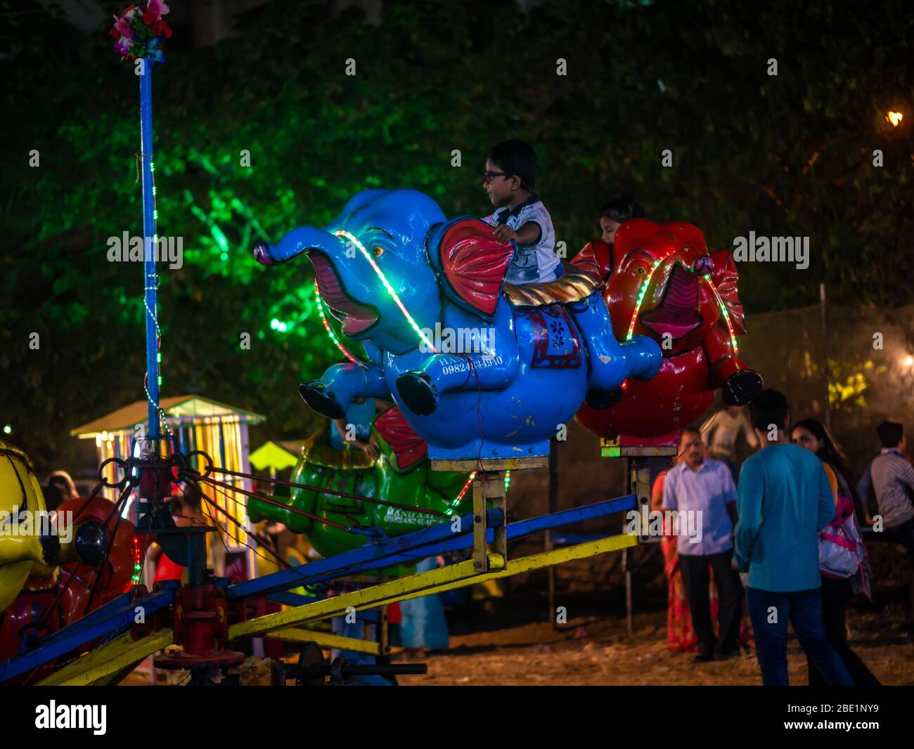 Mumbai, India - December 01, 2019: Indian kids enjoying carousel ride ...