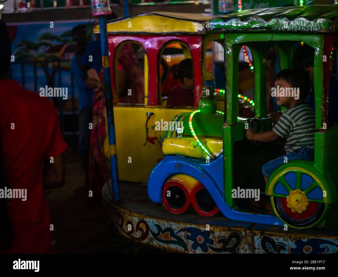 Mumbai, India - December 01, 2019: Indian kid enjoying carousel ride in ...