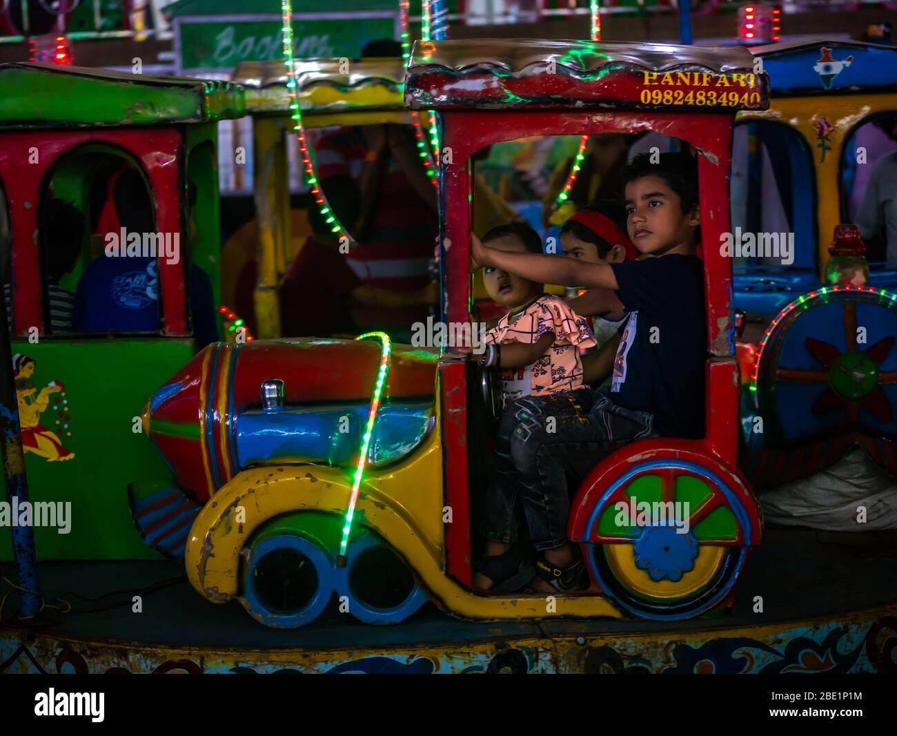 Mumbai, India - December 01, 2019: Indian kid enjoying carousel ride in ...