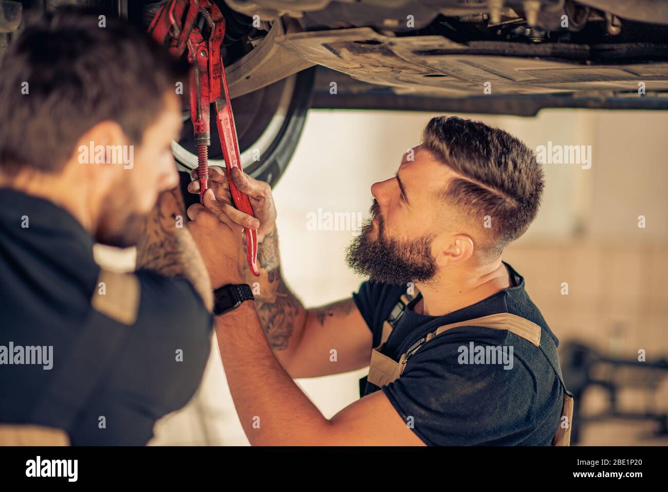 Car mechanics working in auto repair service Stock Photo - Alamy