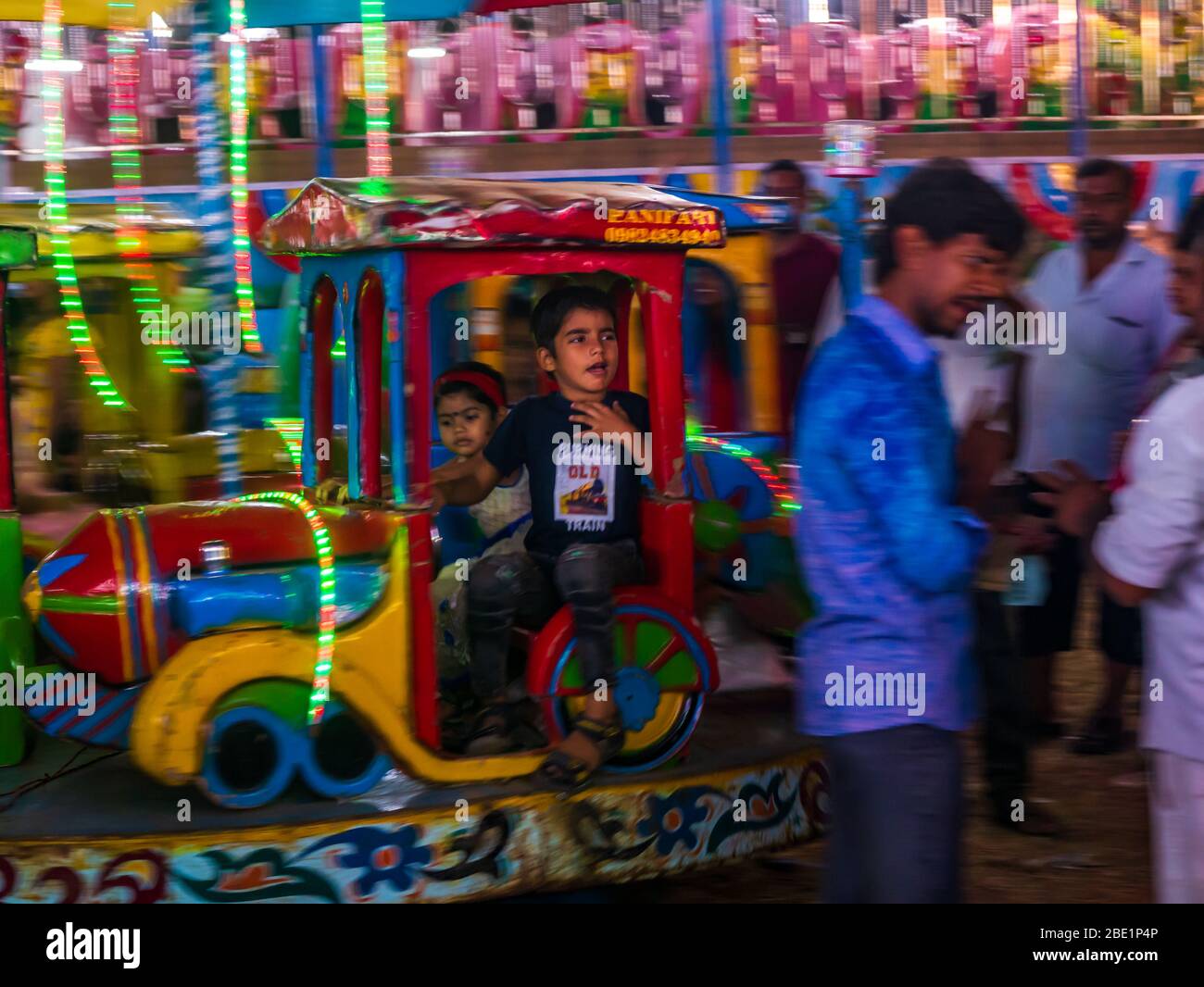Mumbai, India - December 01, 2019: Indian kid enjoying carousel ride in ...