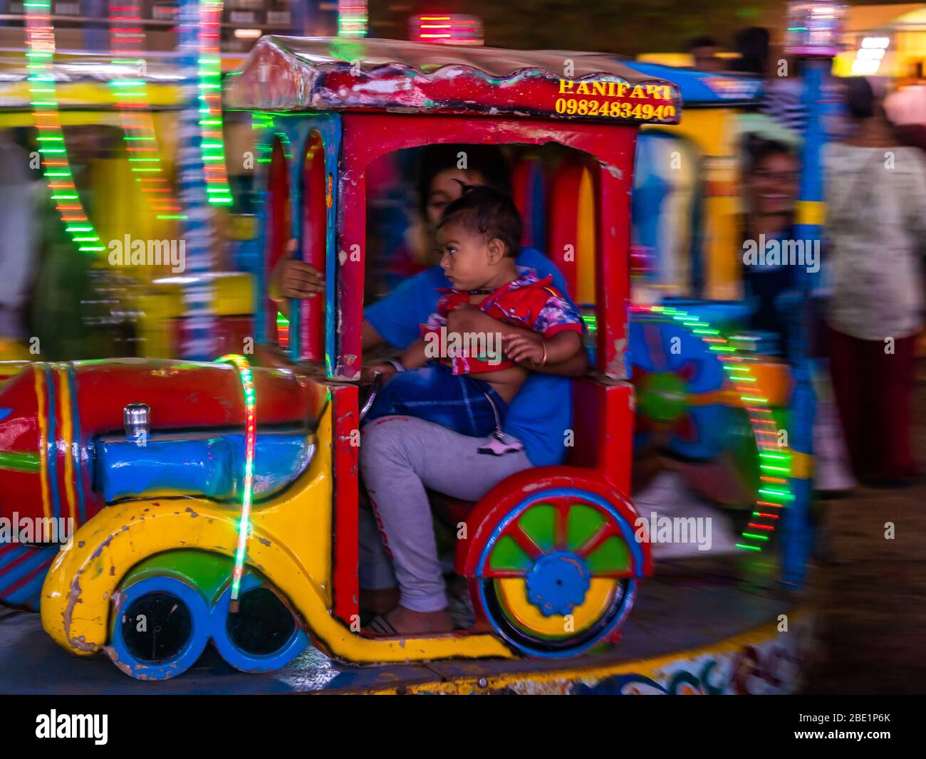 Mumbai, India - December 01, 2019: Indian kid enjoying carousel ride in ...