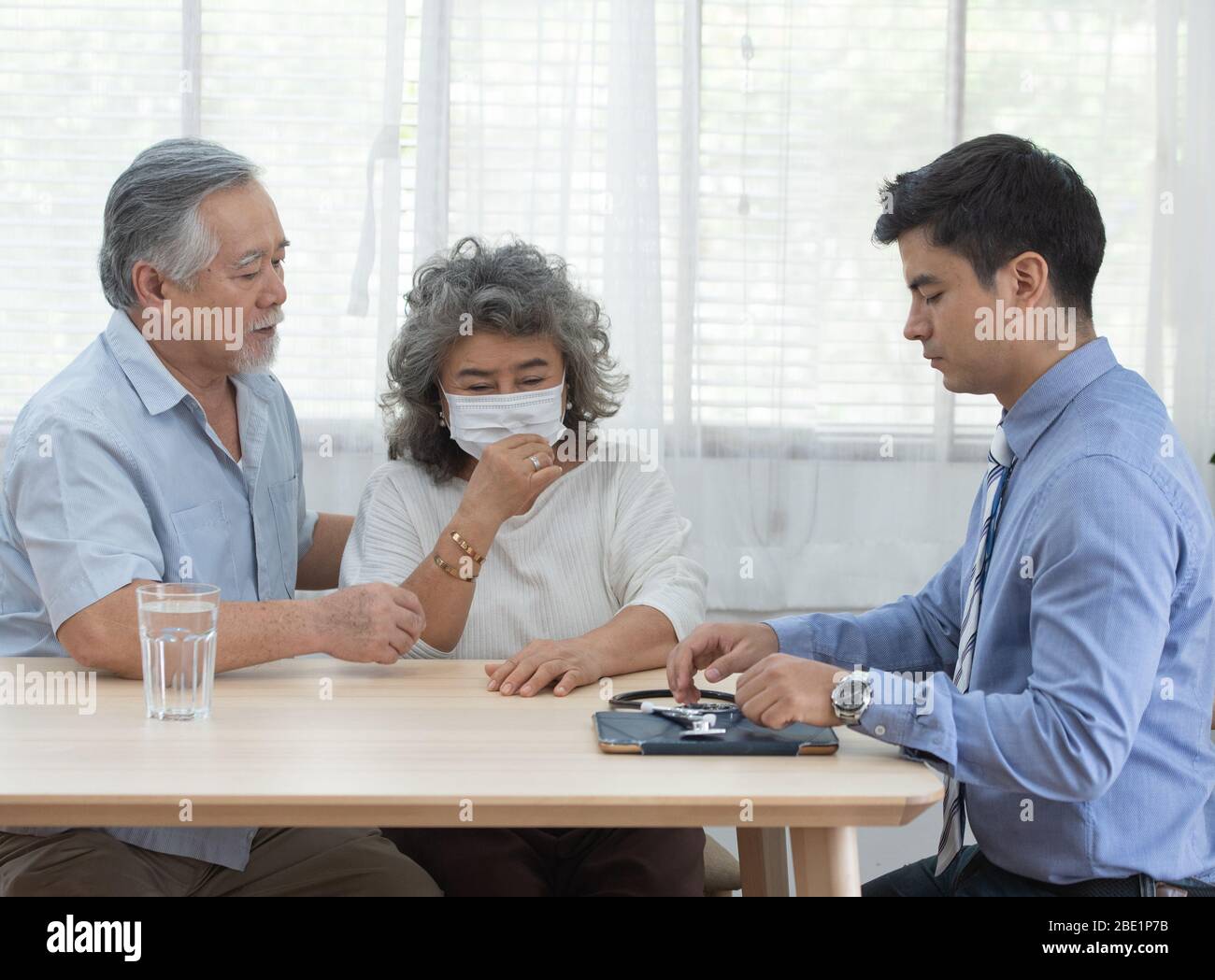 Elder senior old Asian couple meeting specialist professional caucasian ...