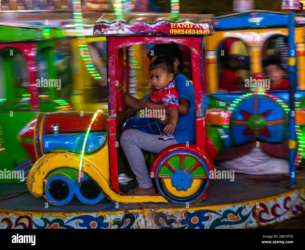 Mumbai, India - December 01, 2019: Indian kid enjoying carousel ride in ...