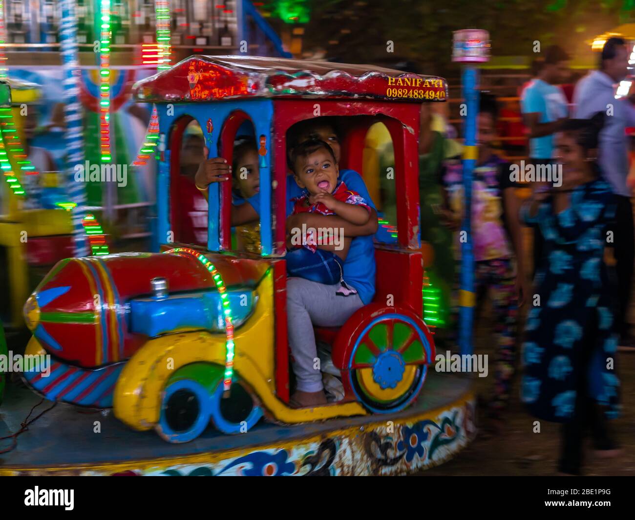Mumbai, India - December 01, 2019: Indian kid enjoying carousel ride in ...