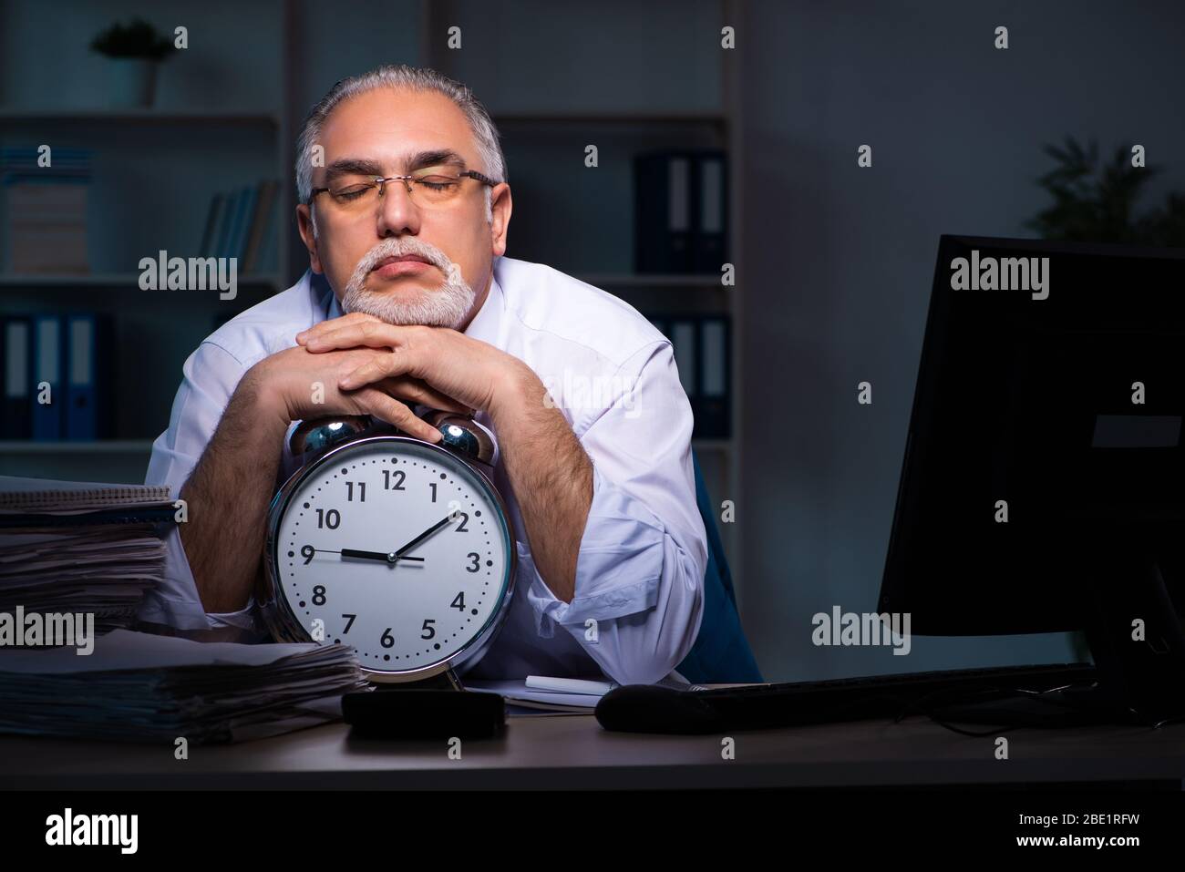 Old employee working late in the office Stock Photo - Alamy