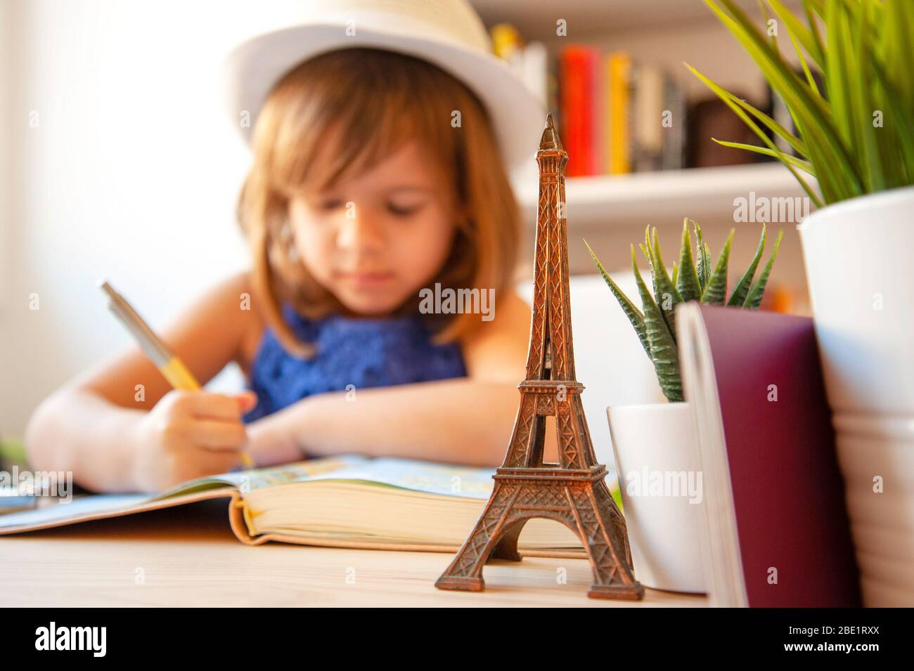 Trendy little girl in summer casual wear and white hat, is doing ...