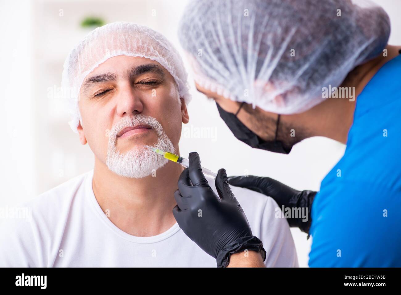 Old man visiting doctor for plastic surgery Stock Photo - Alamy