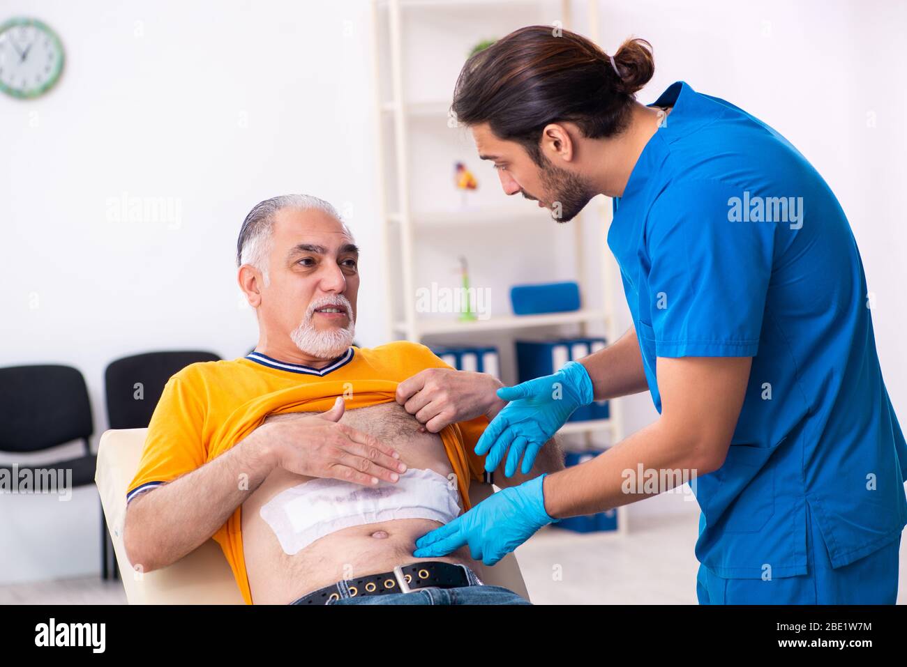 Old man visiting male doctor Stock Photo - Alamy