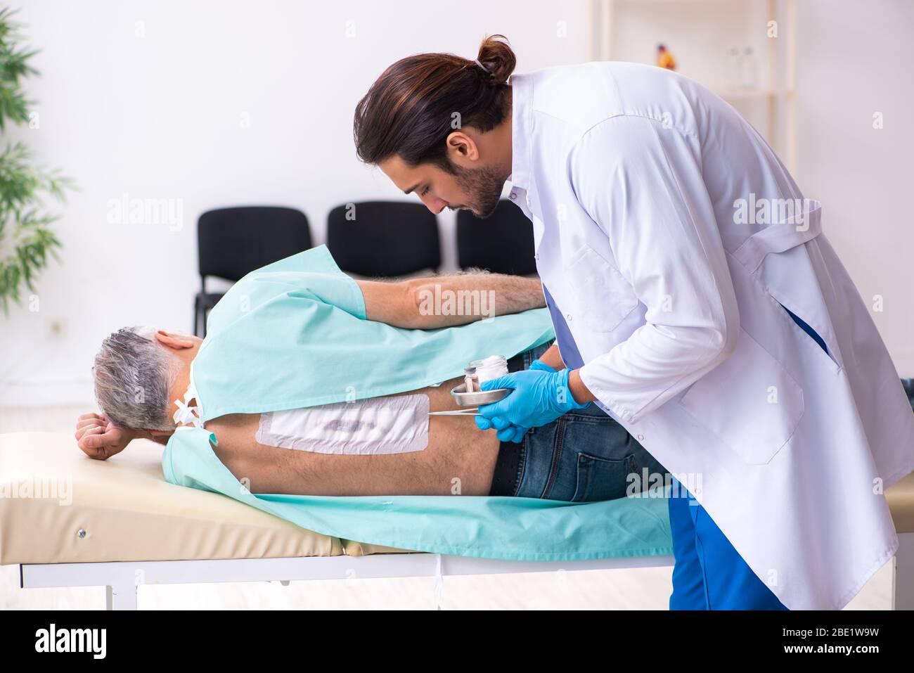 Old man visiting male doctor Stock Photo - Alamy