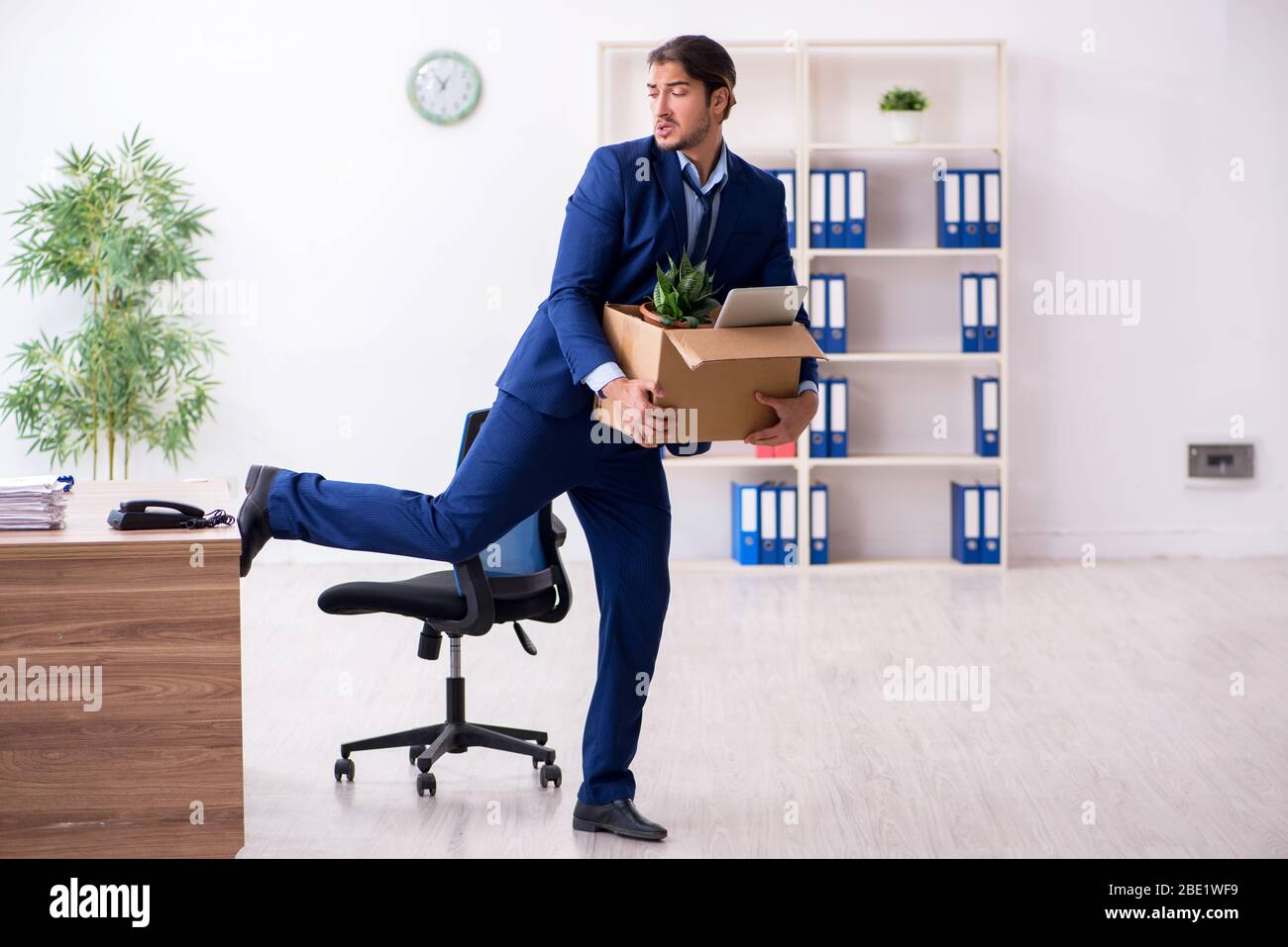 Young man being fired from his workplace Stock Photo - Alamy