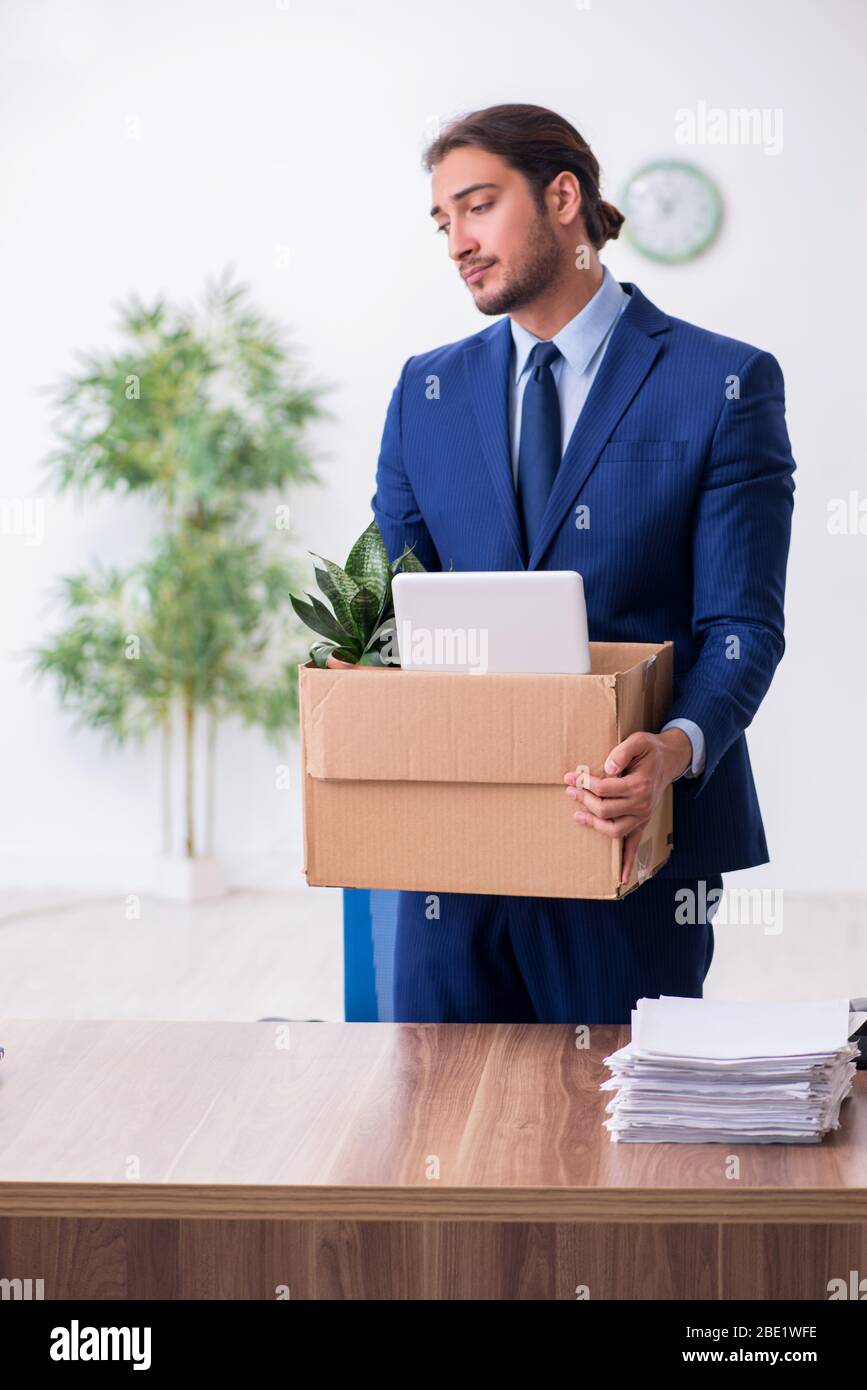 Young man being fired from his workplace Stock Photo - Alamy