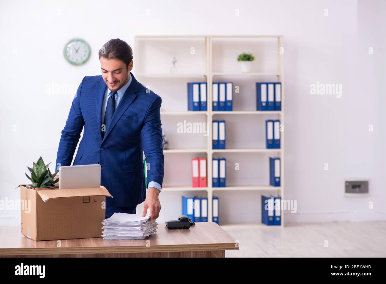 Young man being fired from his workplace Stock Photo - Alamy