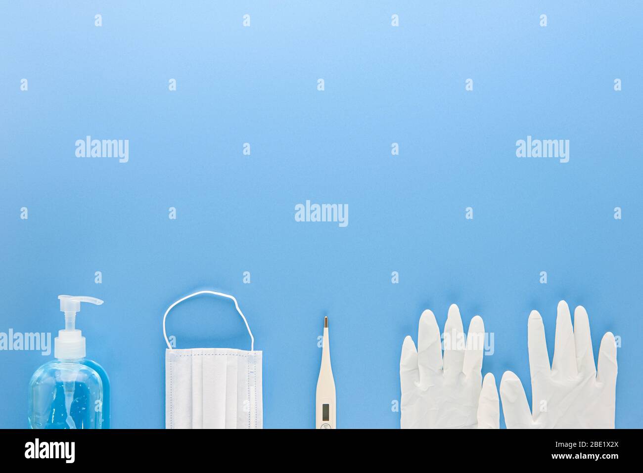 Medical supplies to protect and stay safe from COVID-19 on light blue ...