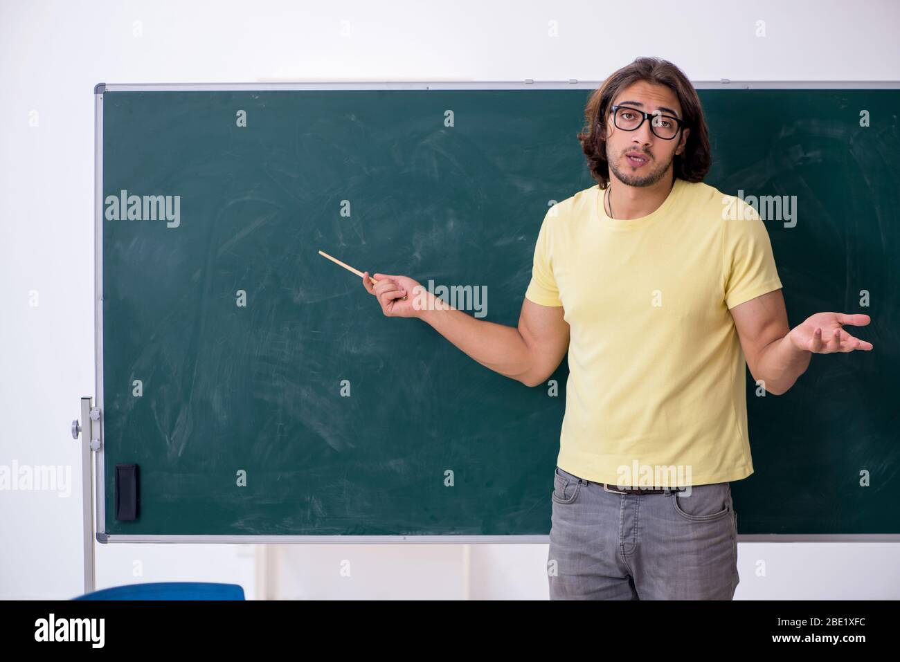 Young student in front of blackboard Stock Photo - Alamy