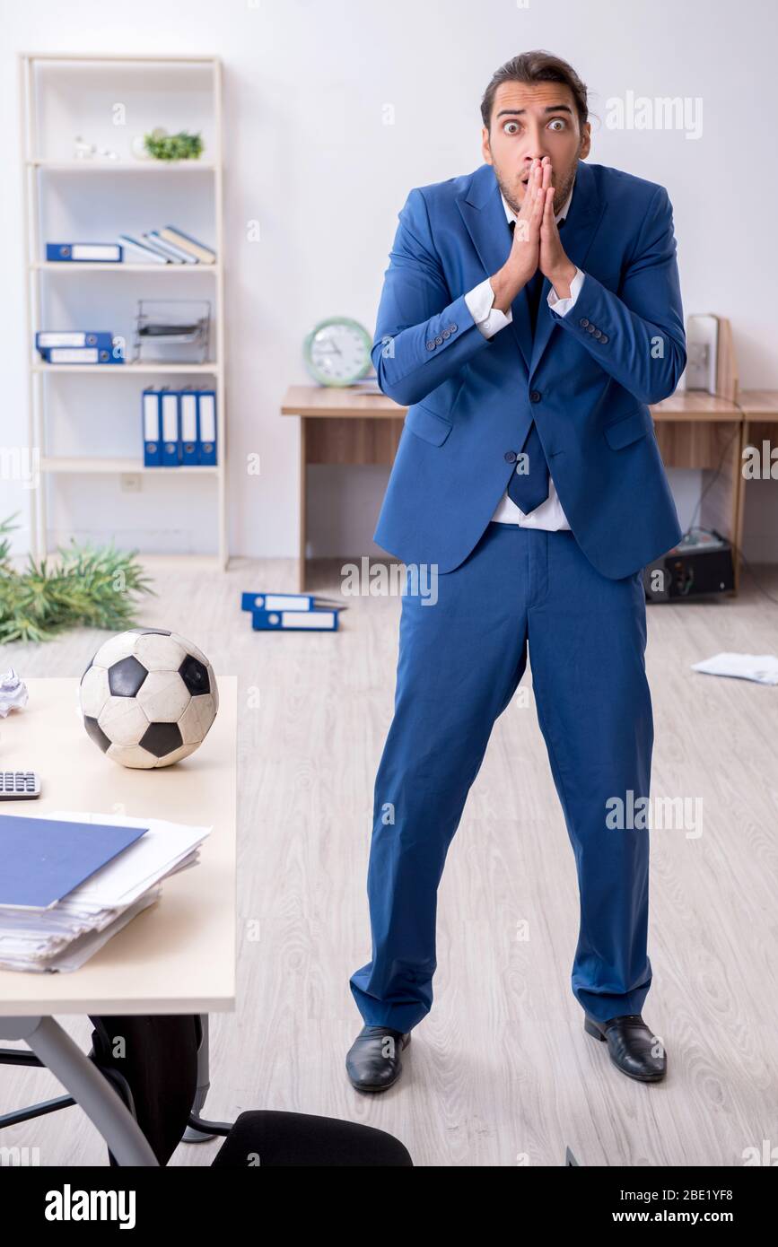 Young employee playing football in the office Stock Photo - Alamy
