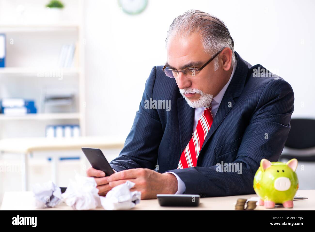 Old accountant in budget planning concept Stock Photo - Alamy