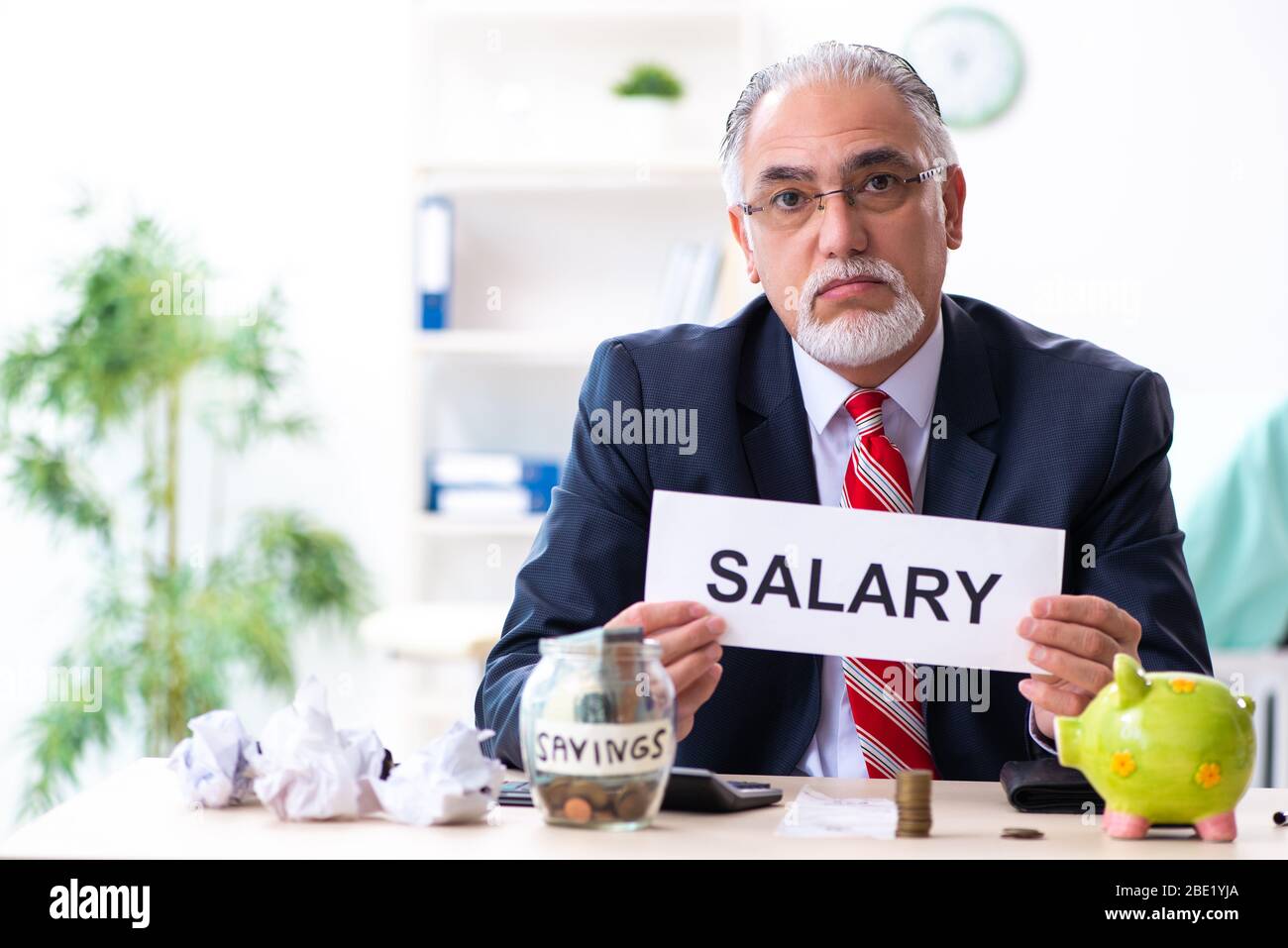 Old accountant in budget planning concept Stock Photo - Alamy