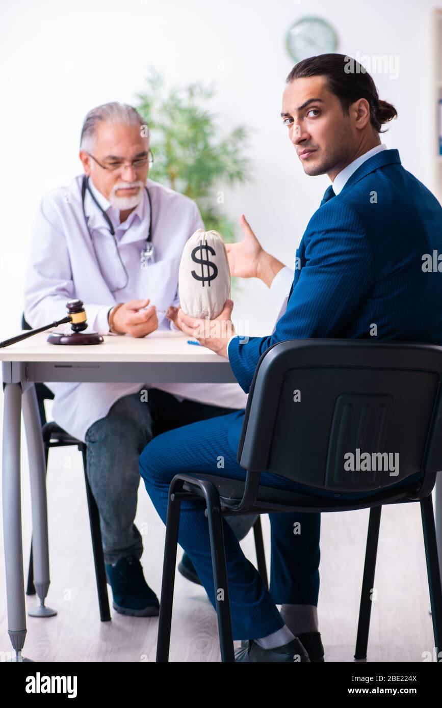 Doctor in courthouse meeting with lawyer Stock Photo - Alamy