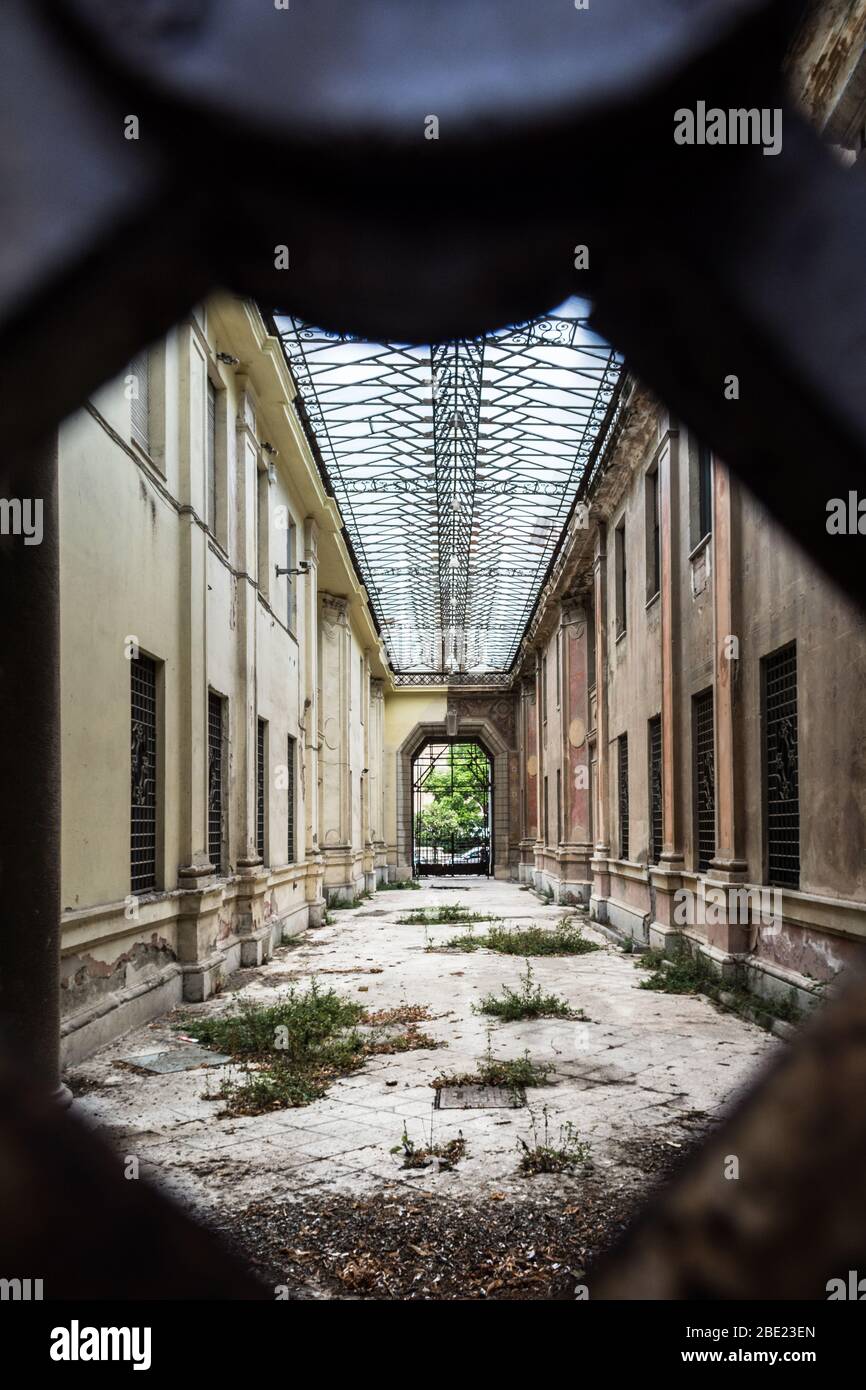 Column framed ancient arch which is closed view into atrium Messina ...