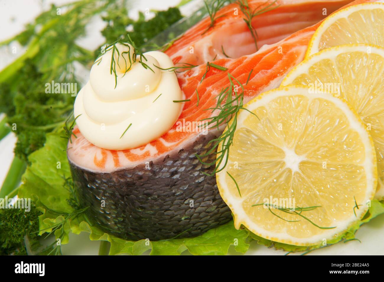 Salmon steak with sauce, herbs and lemon Stock Photo - Alamy
