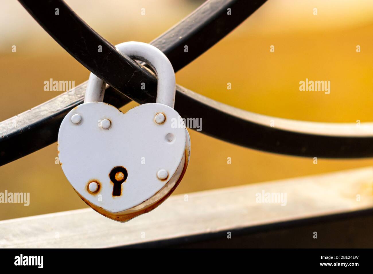 White wedding lock on a fence. Symbol of love, marriage and happiness ...