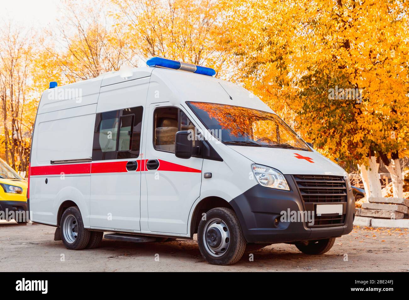 An ambulance is standing in the courtyard of the hospital. Side view of ...