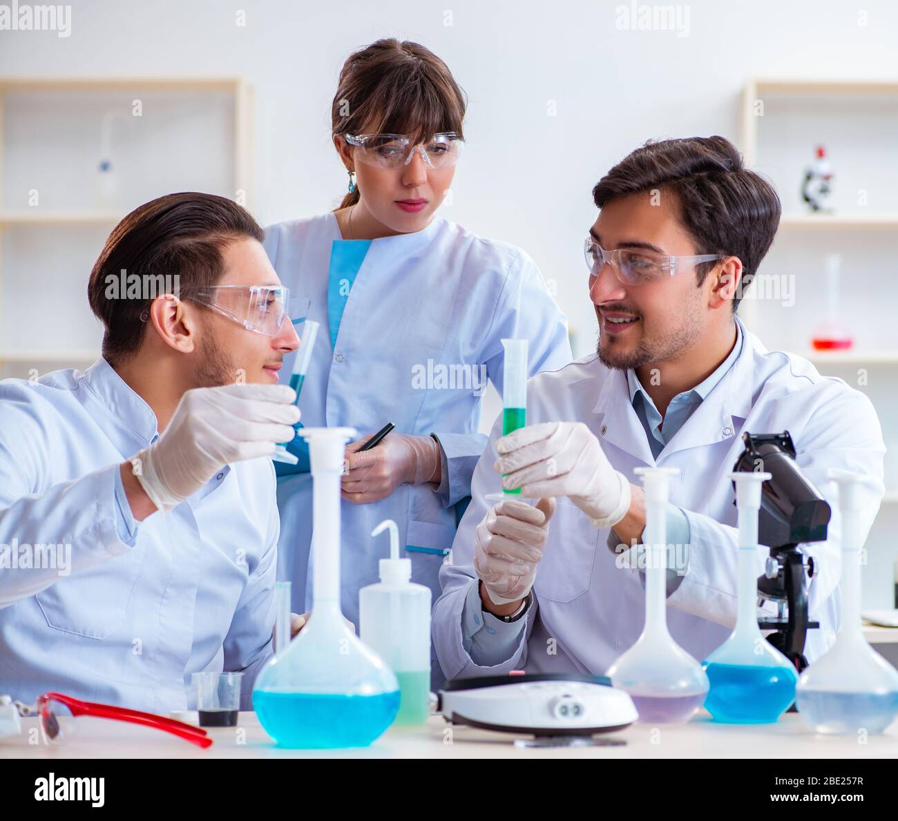 The team of chemists working in the lab Stock Photo - Alamy