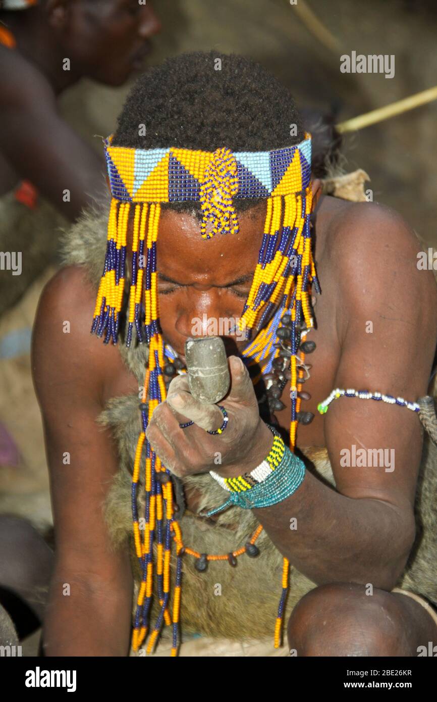 Hadza man smoking from a traditional clay pipe Photographed near Lake ...
