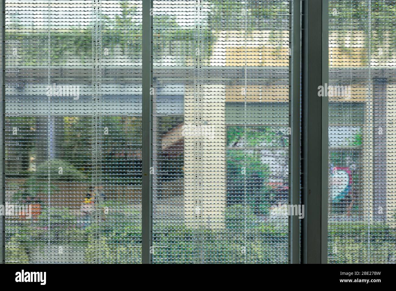 Urban view through window with partially opened blinds Stock Photo - Alamy