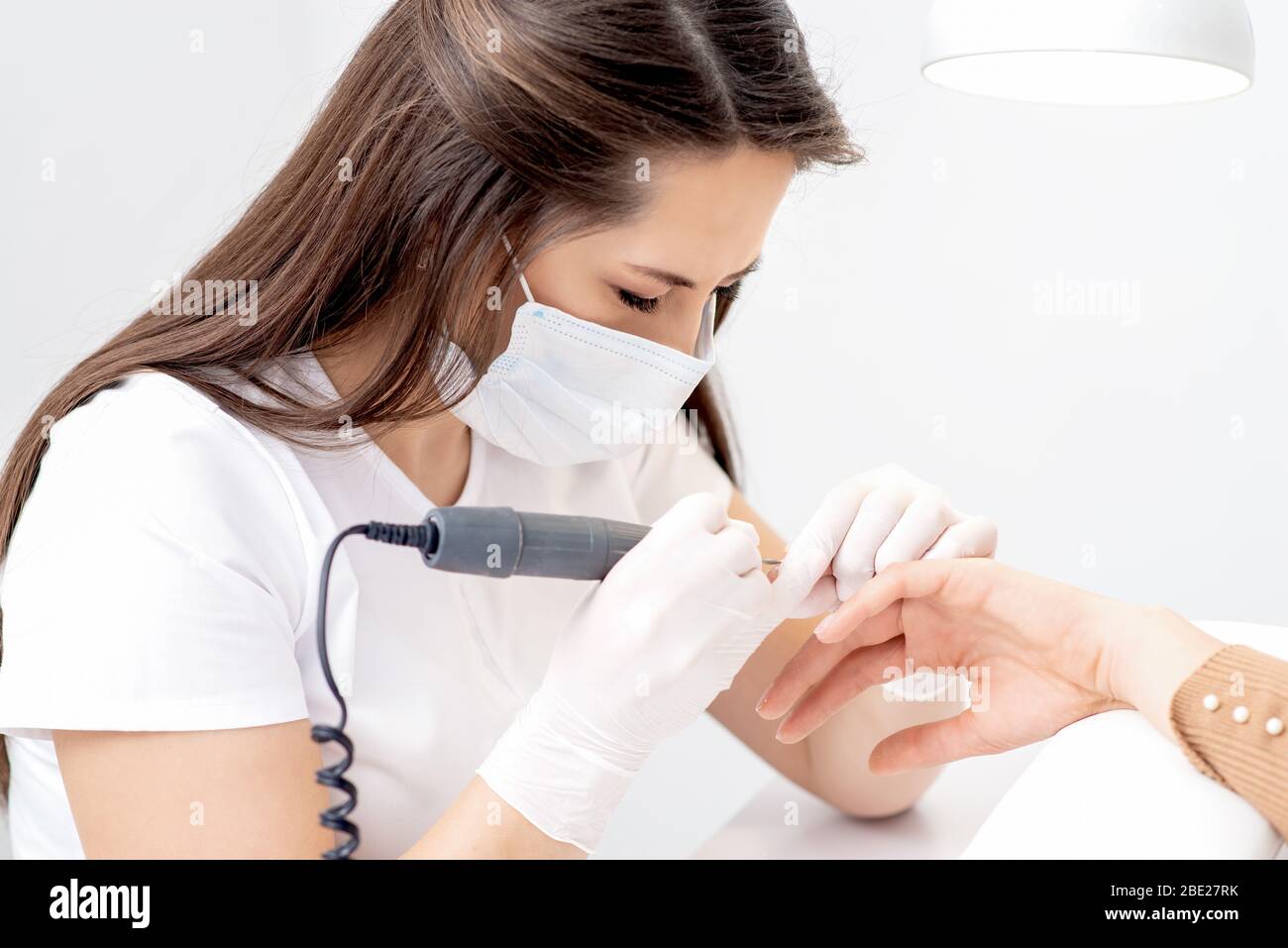 Manicure master making manicure with electric machine tool Stock Photo ...