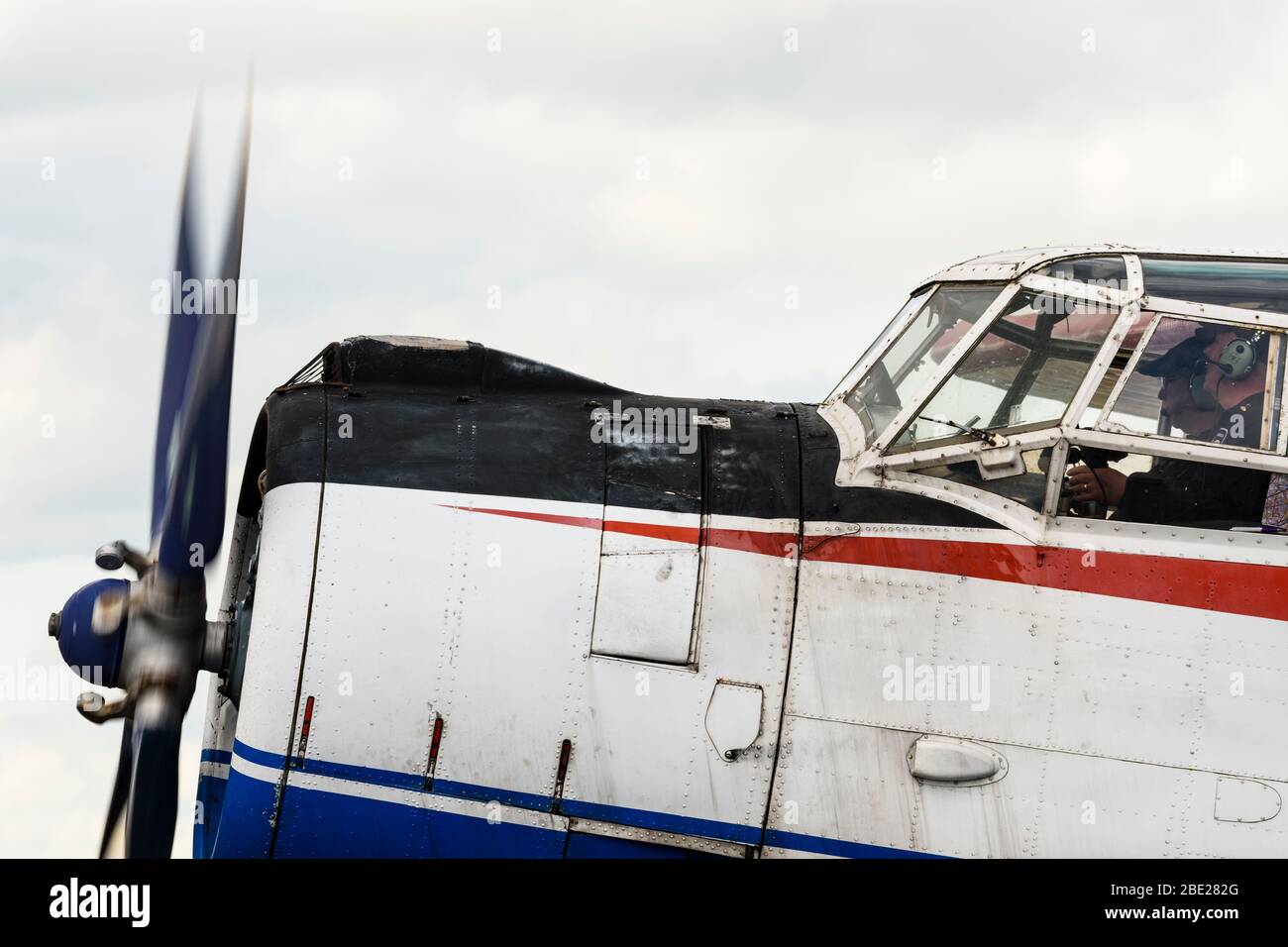 Closeup side view of an Antonov AN-2 aircraft cockpit and spinning ...