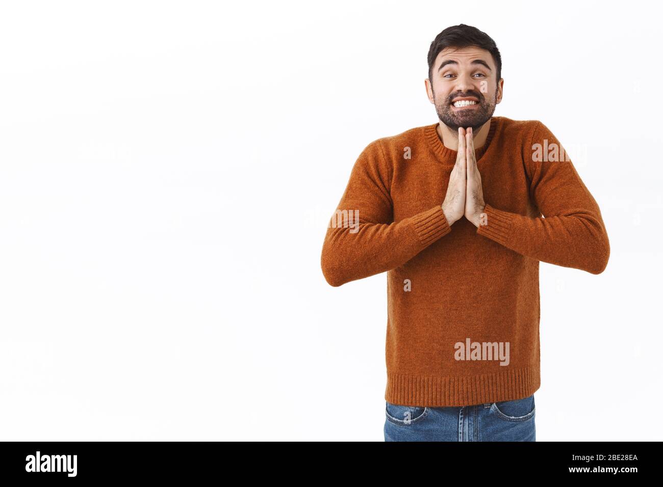 Portrait of silly and cute smiling handsome man, begging for help, need ...