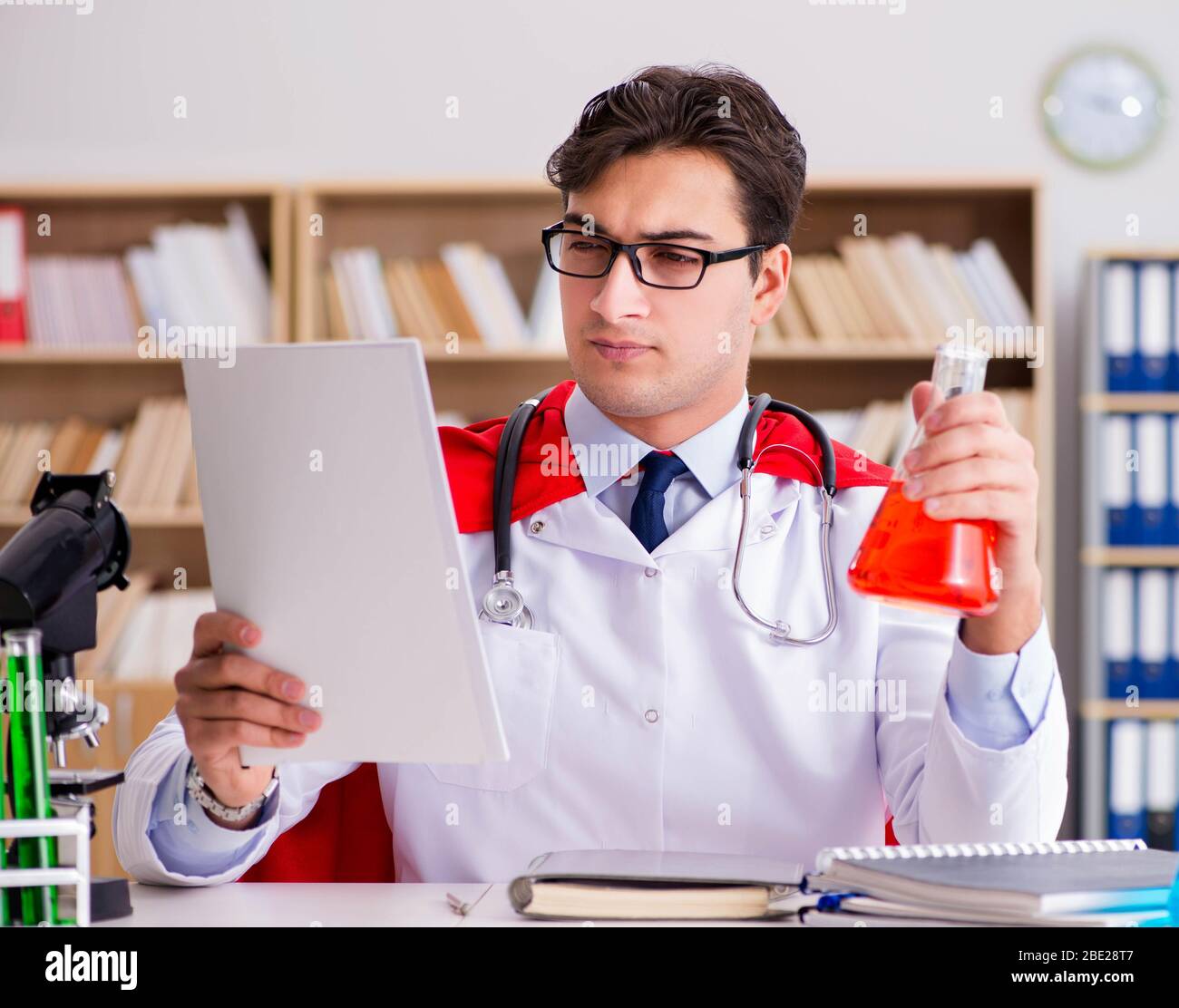 The superhero doctor working in the lab hospital Stock Photo - Alamy