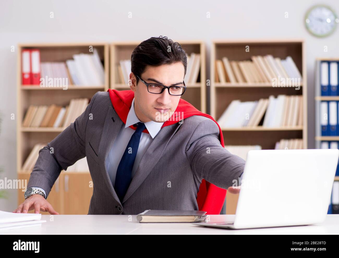The superhero businessman working in the office Stock Photo - Alamy