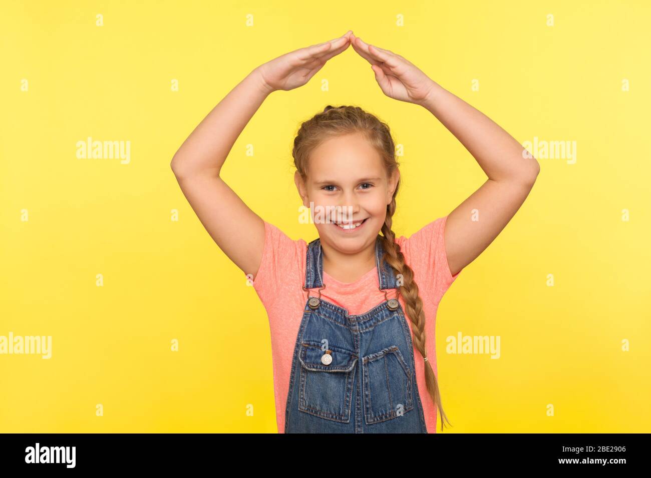 Child feel safe. Portrait of happy little girl with braid in denim ...