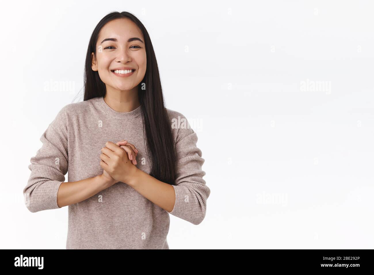 Grateful happy, smiling east-asian woman with long dark hair, clasp ...