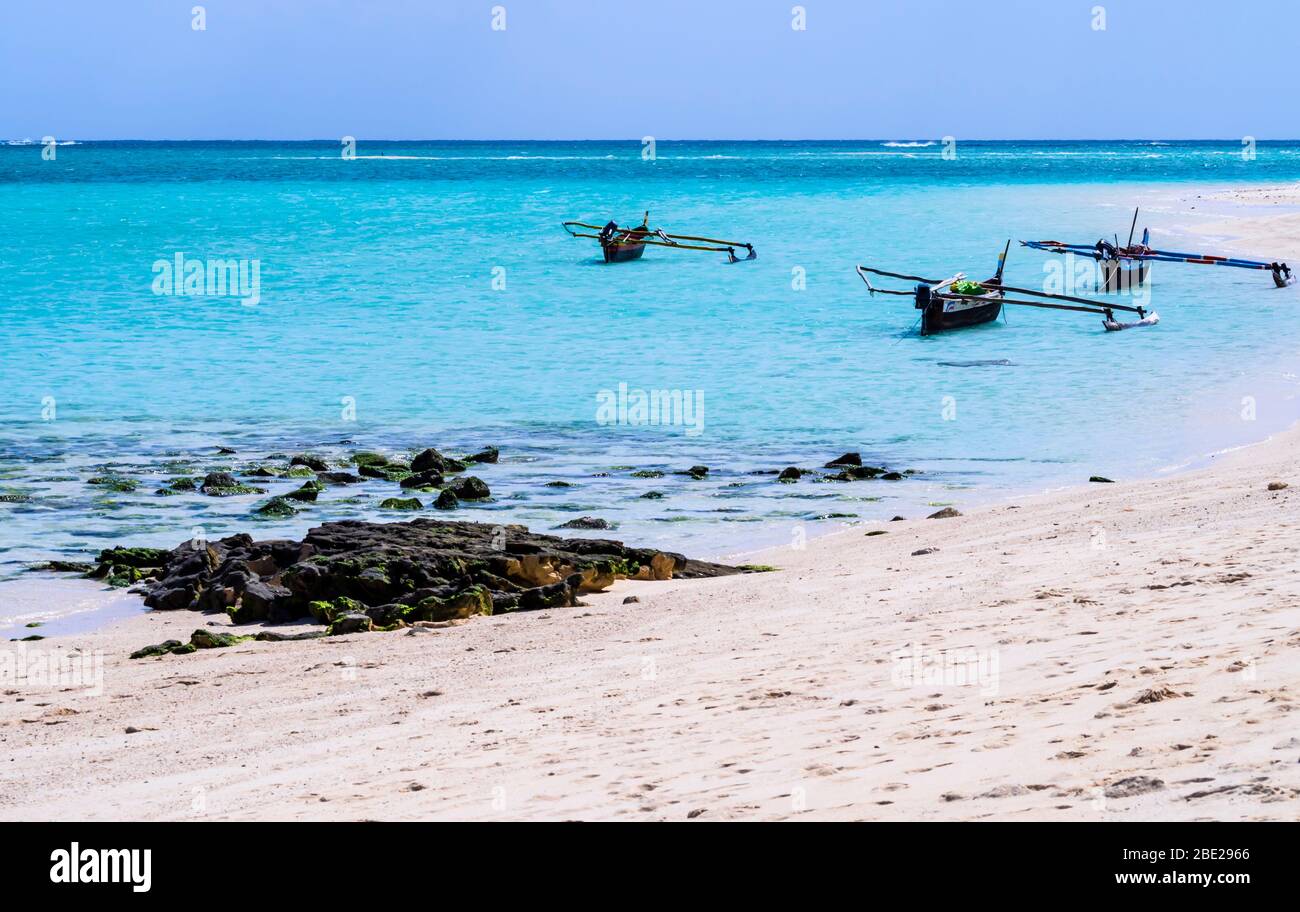 Stunning white sand beach of Nosy Ve island with typical outrigger ...