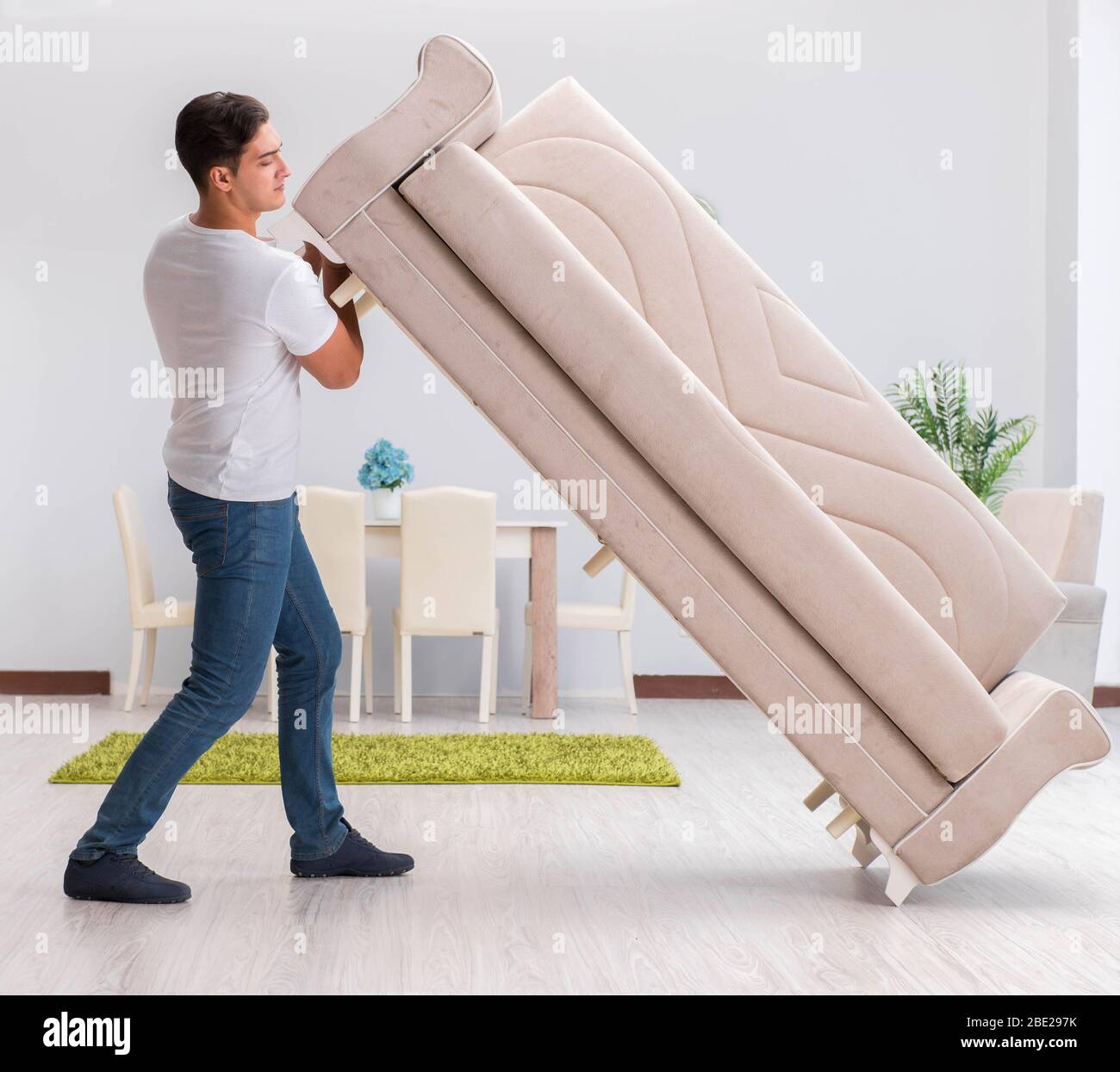 The man moving furniture at home Stock Photo - Alamy