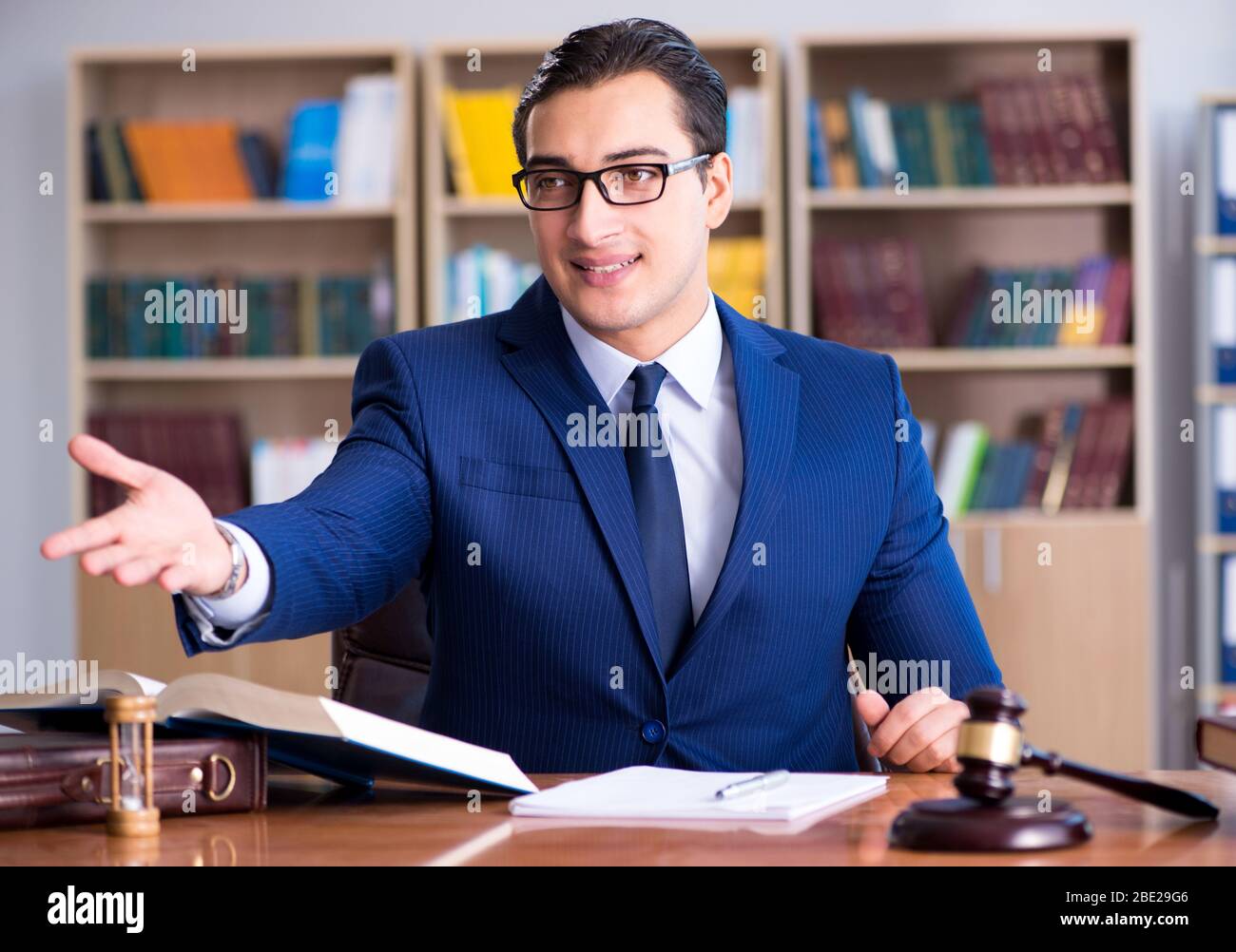 The handsome judge with gavel sitting in courtroom Stock Photo - Alamy