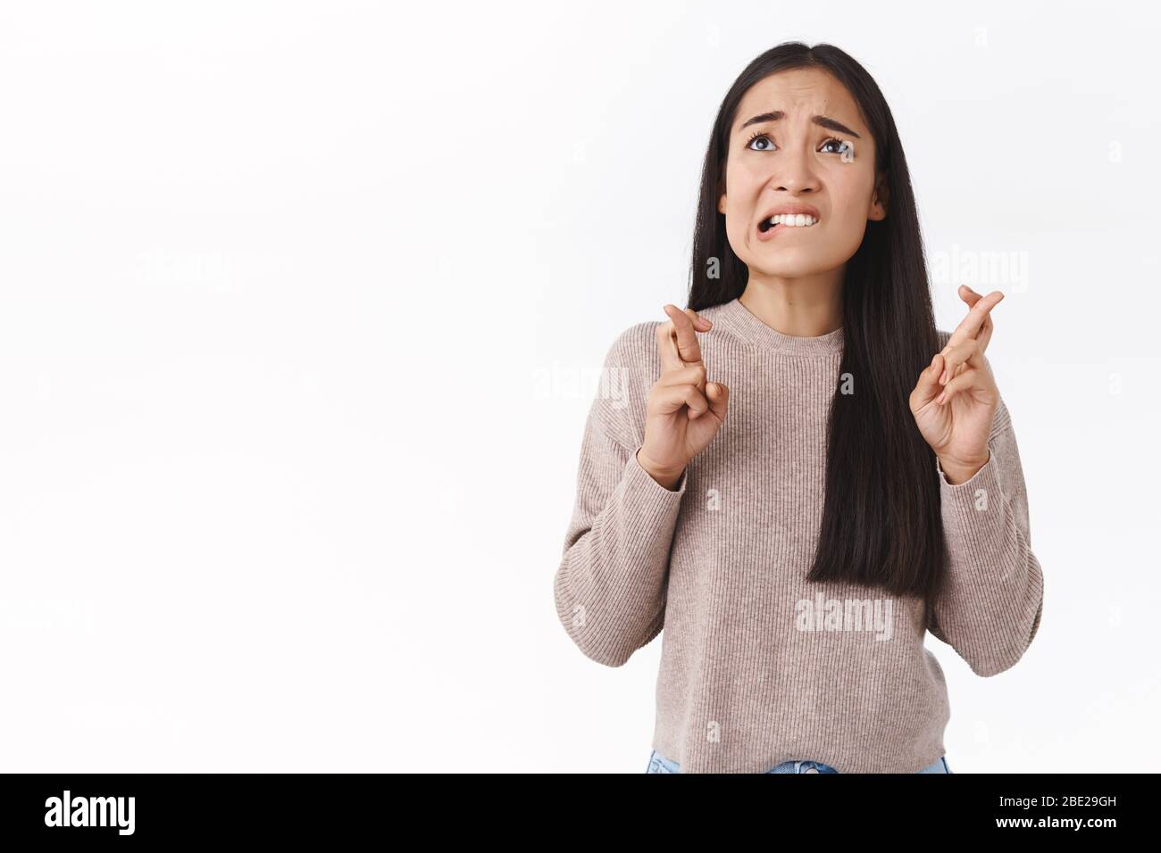 Troubled, worried cute asian girl in beige blouse, have concernes ...